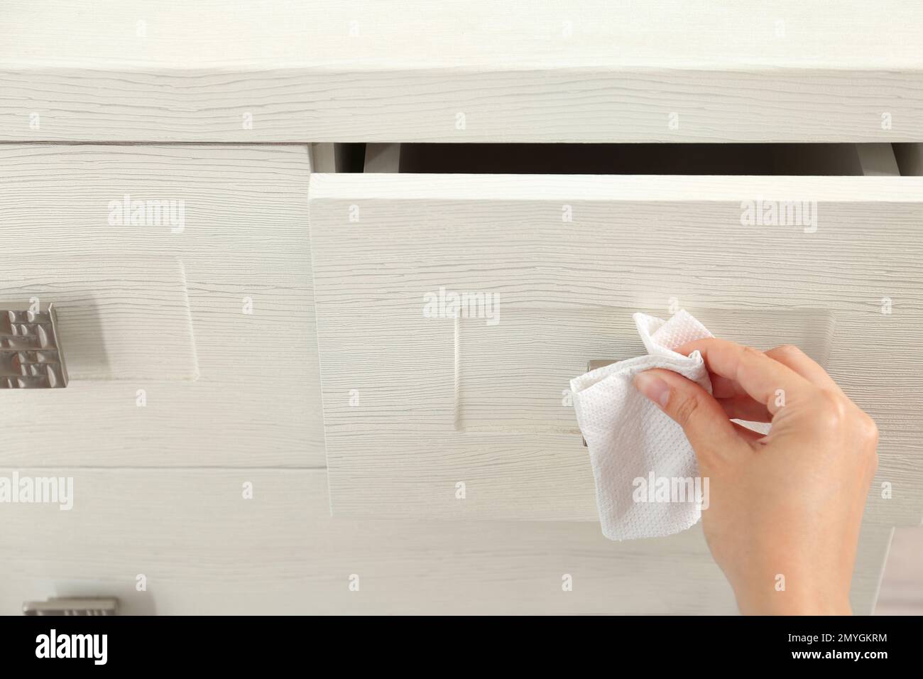 Woman using tissue paper to open drawer, closeup Stock Photo - Alamy