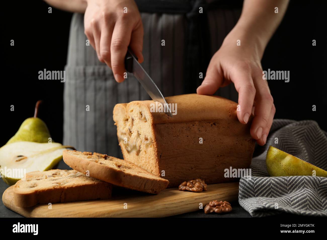 Woman cutting pear bread hi-res stock photography and images - Alamy