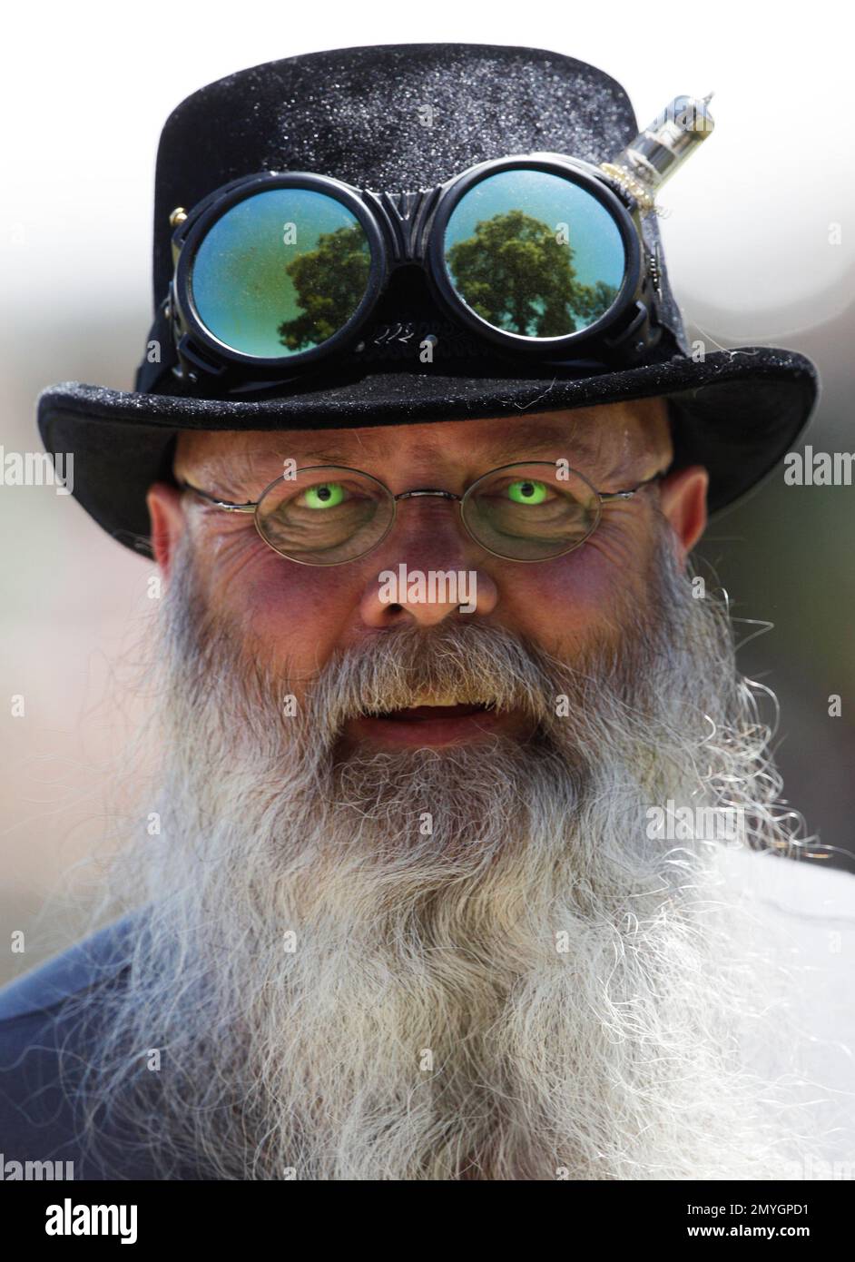 Ted Lester, wearing fluorescent contact lenses, walks through the crowd ...