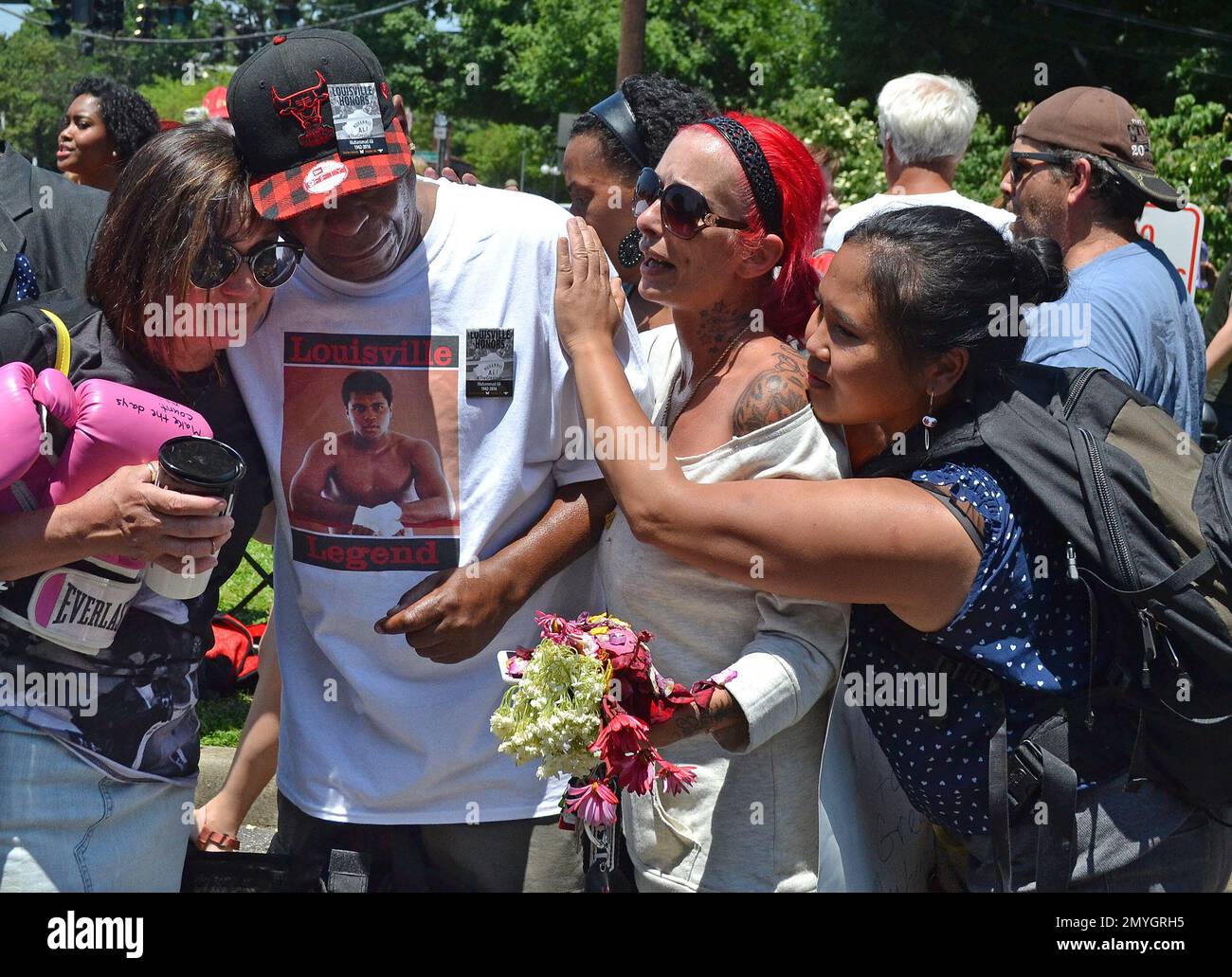 Gerald Wayne Jacobs, of Louisville, is consoled by strangers as he ...