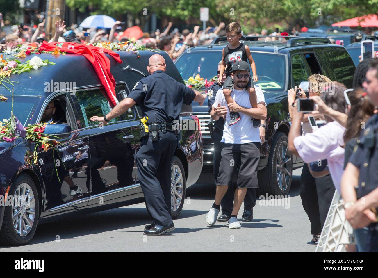 Spectators are moved away from the hearse carrying Muhammad Ali as his ...
