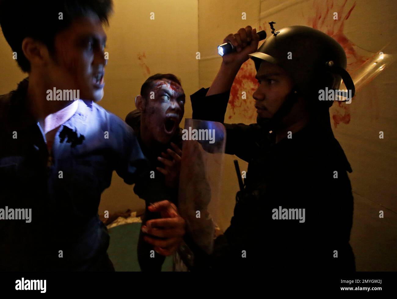 Actors play as zombies and prison warden during the media tour at the ...