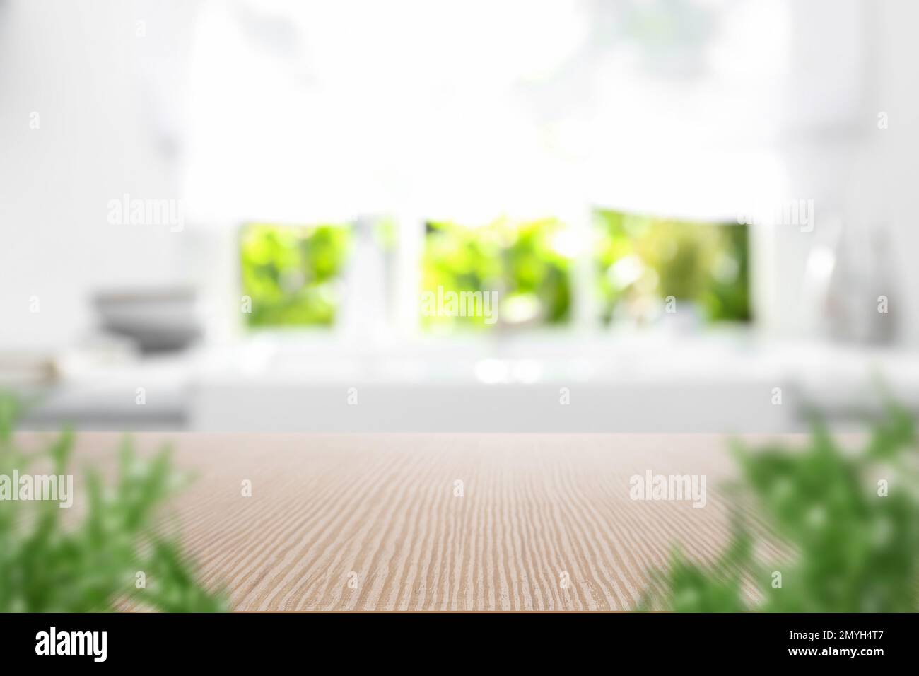 Wooden table in light kitchen. Space for design Stock Photo - Alamy