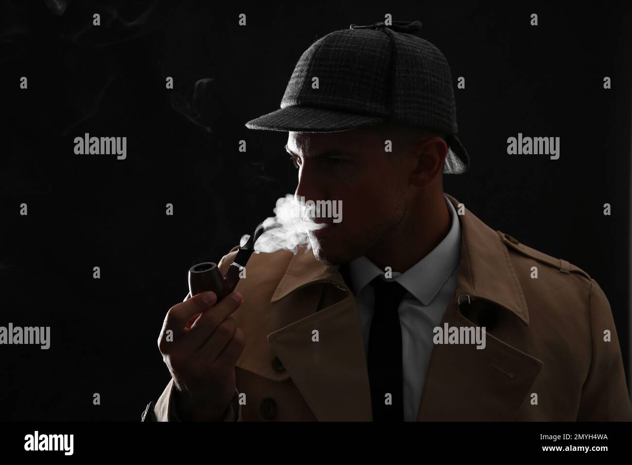 Old fashioned detective smoking pipe on dark background Stock Photo - Alamy