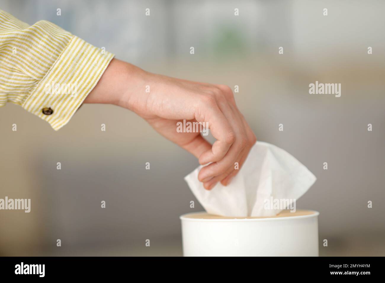 Woman taking paper tissue from holder indoors, closeup Stock Photo - Alamy