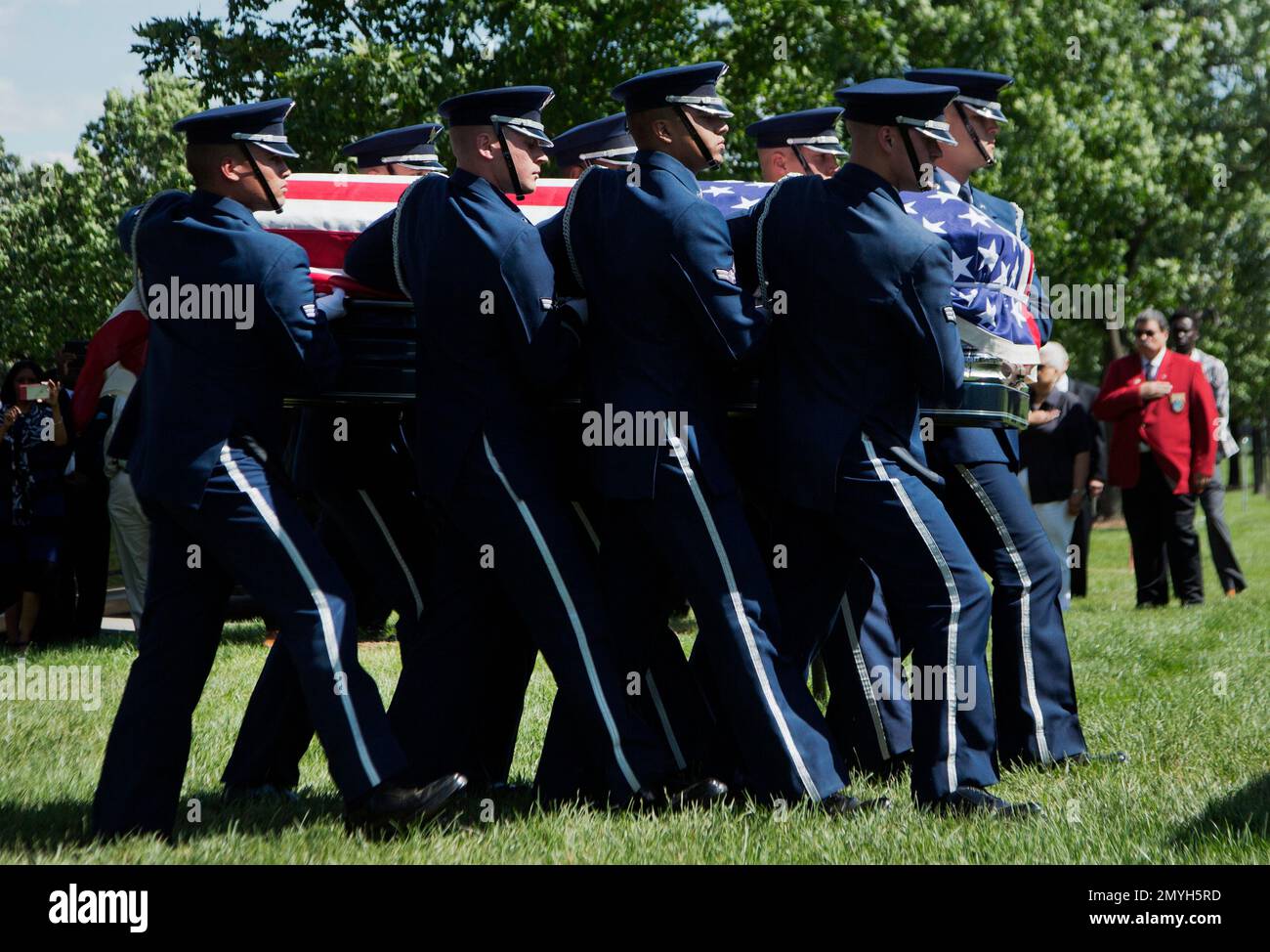 An Air Force honor guard carry the casket containing the remains of ...
