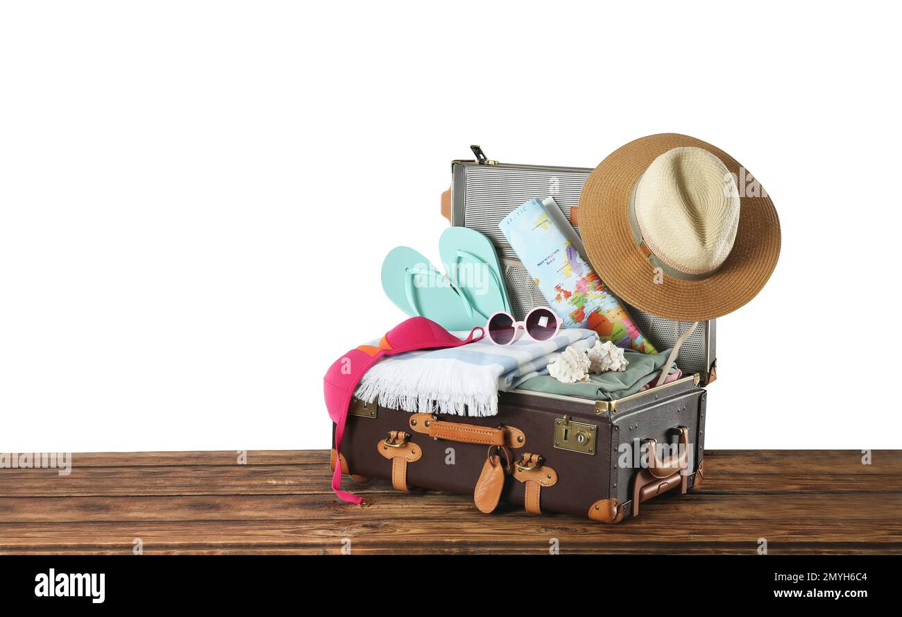 Open vintage suitcase with different beach objects packed for summer ...