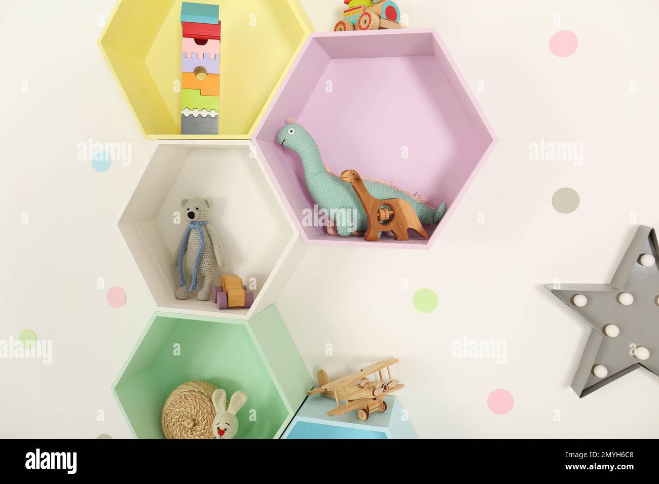 Bright colorful shelves on light wall. Interior design Stock Photo - Alamy