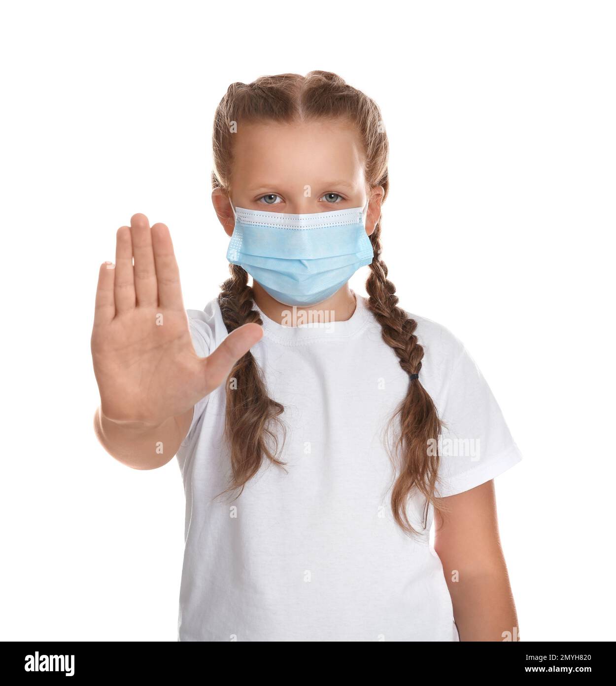 Little girl in protective mask showing stop gesture on white background ...