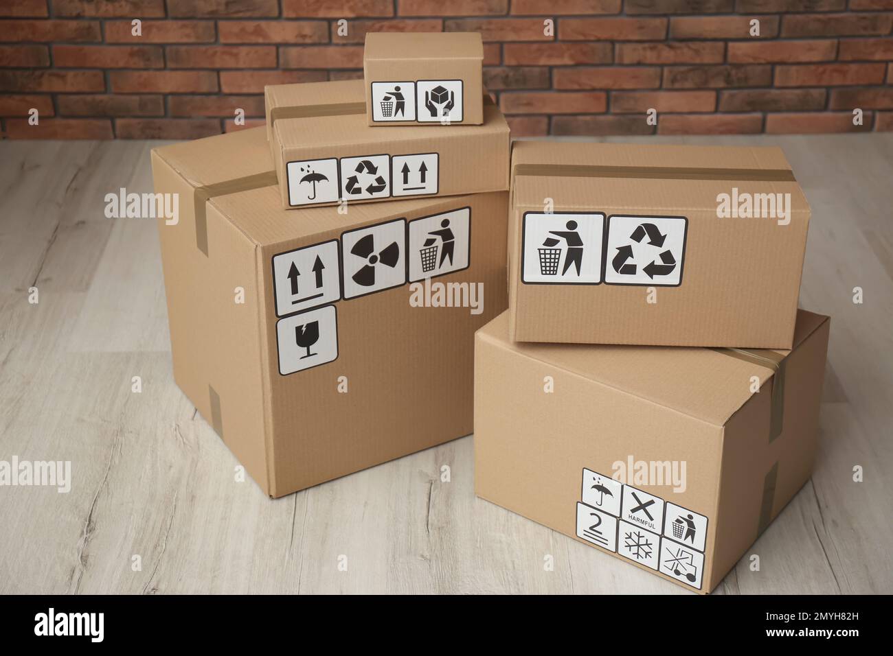 Cardboard boxes with different packaging symbols on floor. Parcel ...