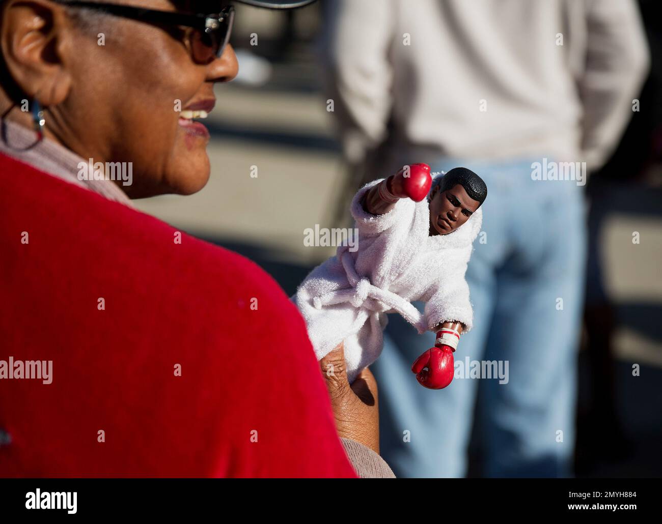 Barbara Hillman, of Louisville, carries a Muhammad Ali doll after ...