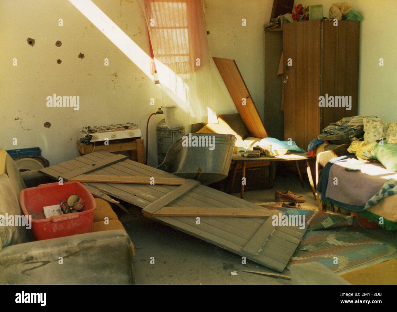 Bullet marks on the wall and a wrecked room of a house which was part ...