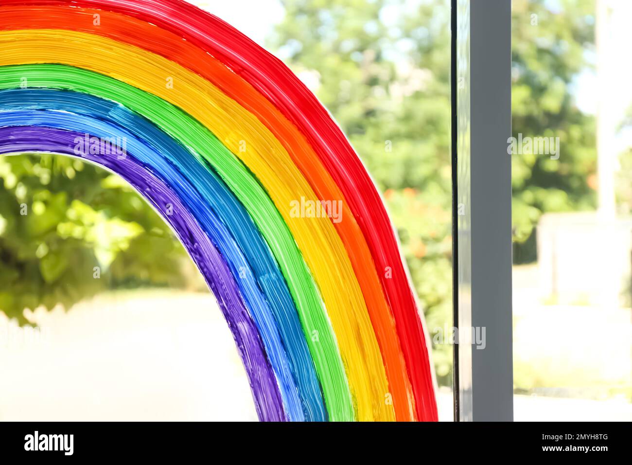Painting of rainbow on window, closeup. Stay at home concept Stock ...