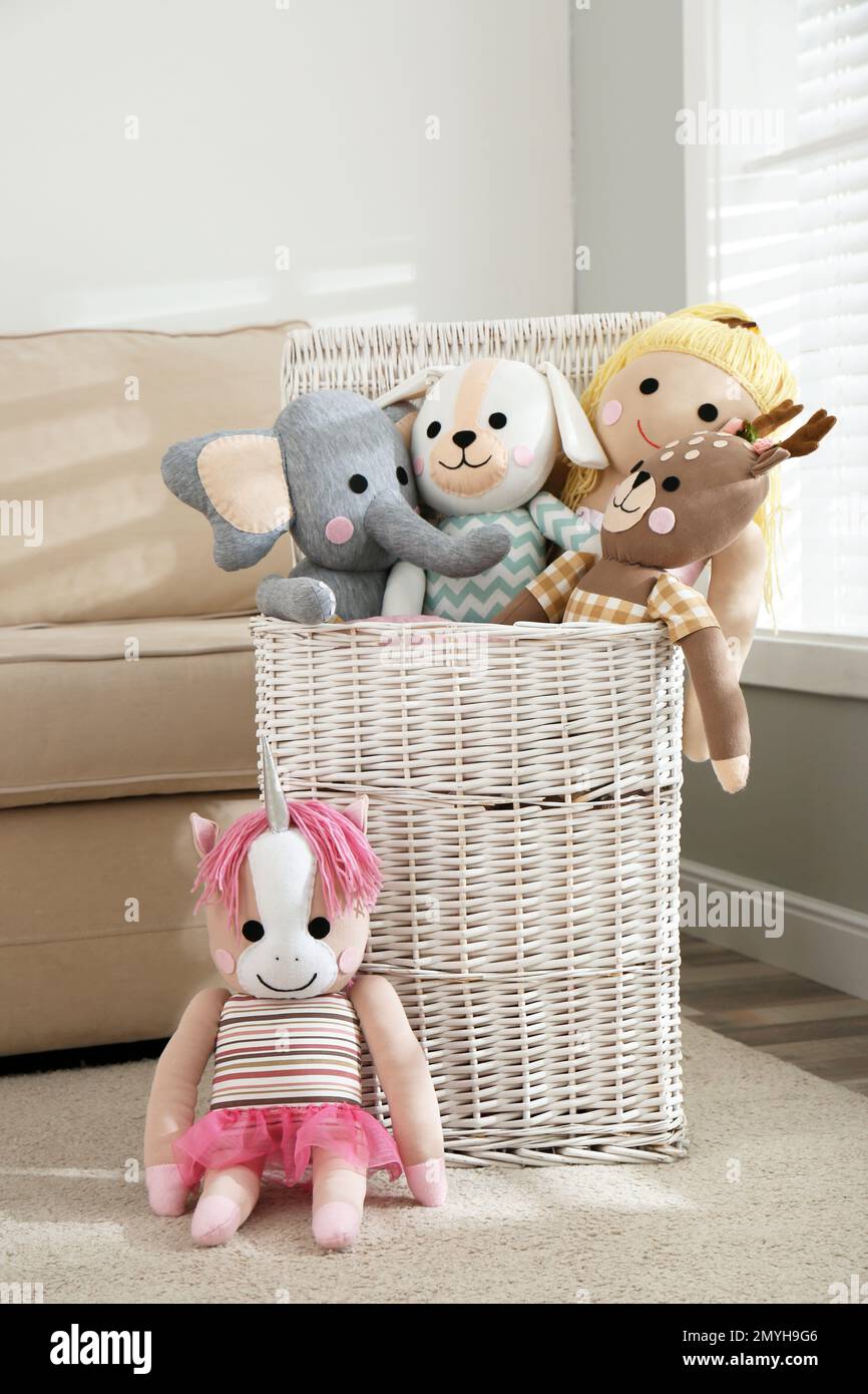 Funny stuffed toys and basket in children's room. Interior decor Stock ...