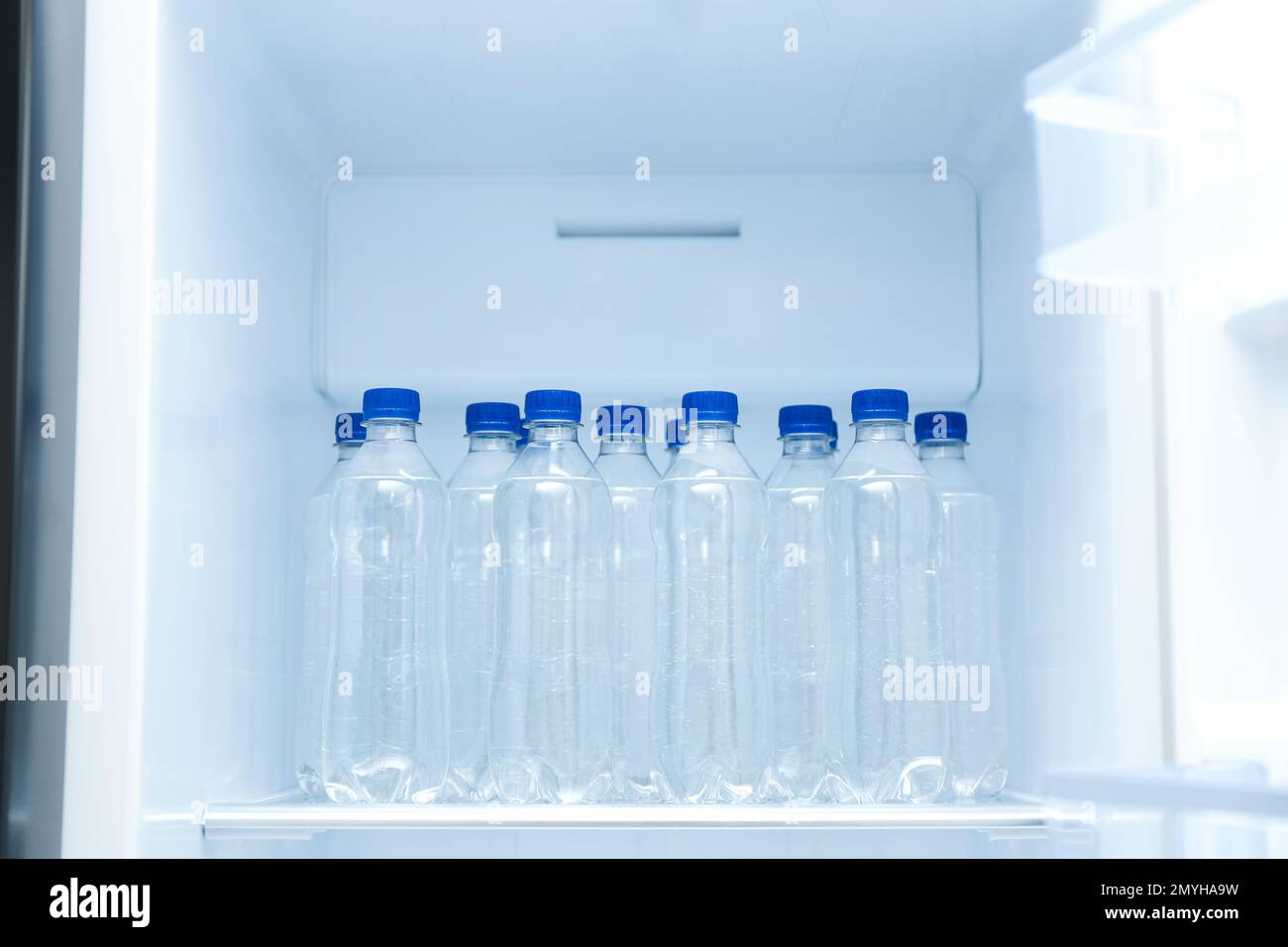 Bottles of pure water on shelf inside refrigerator Stock Photo - Alamy