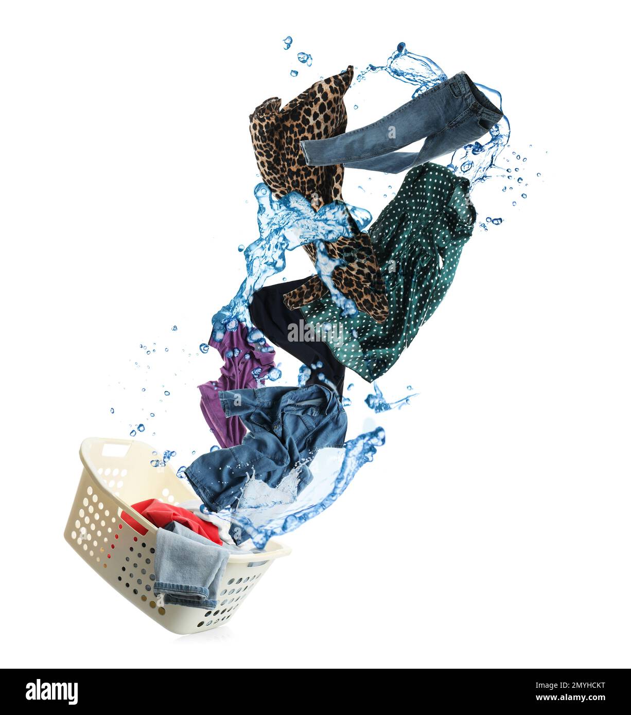 Different clothes with water splash falling into laundry basket against ...