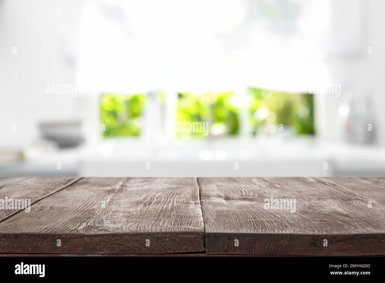 Wooden table in light kitchen. Space for design Stock Photo - Alamy