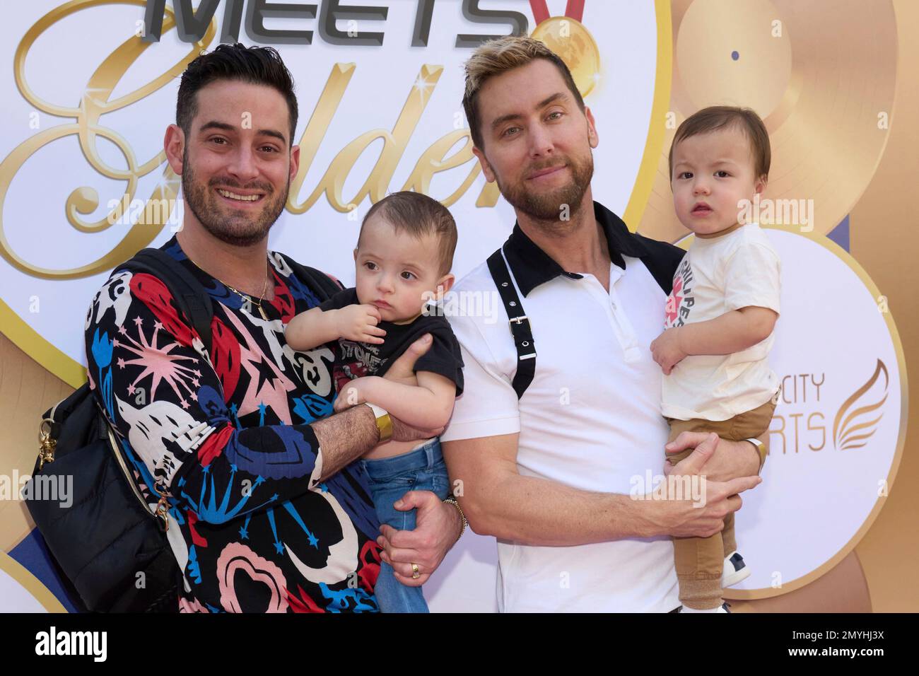 Michael Turchin, left, Lance Bass, and children arrive at the 10th ...