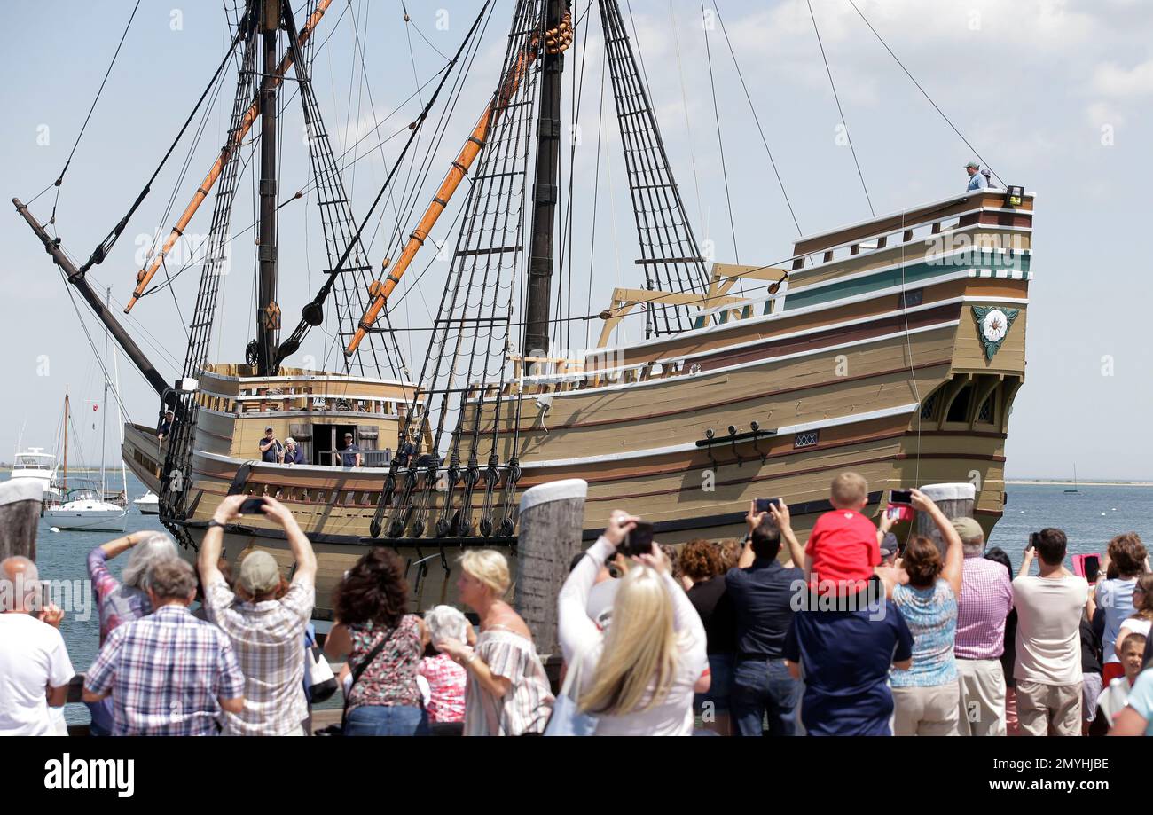 People on a wharf, bottom, watch as the Mayflower II arrives in ...