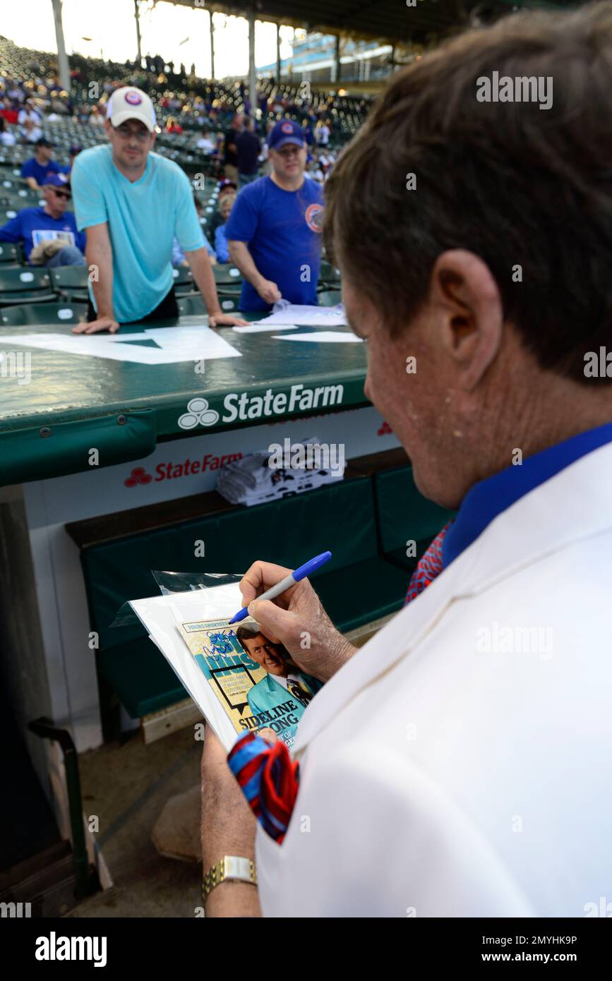 Broadcaster Craig Sager signs an autograph before throwing out the ...