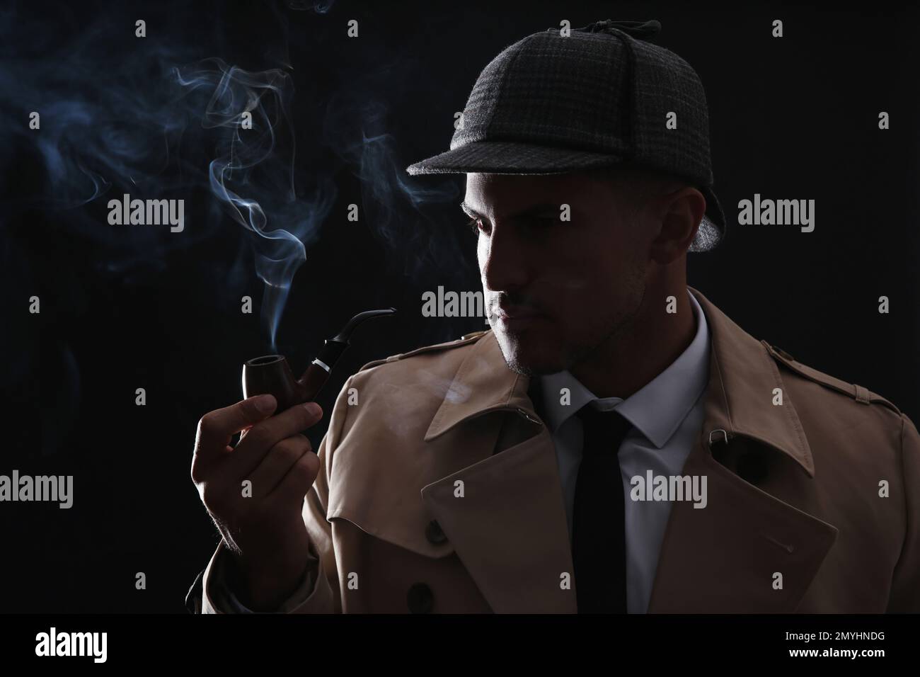 Old fashioned detective smoking pipe on dark background Stock Photo - Alamy
