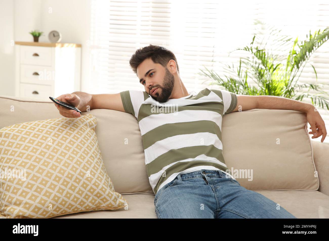 Lazy guy on couch watching hi-res stock photography and images - Alamy