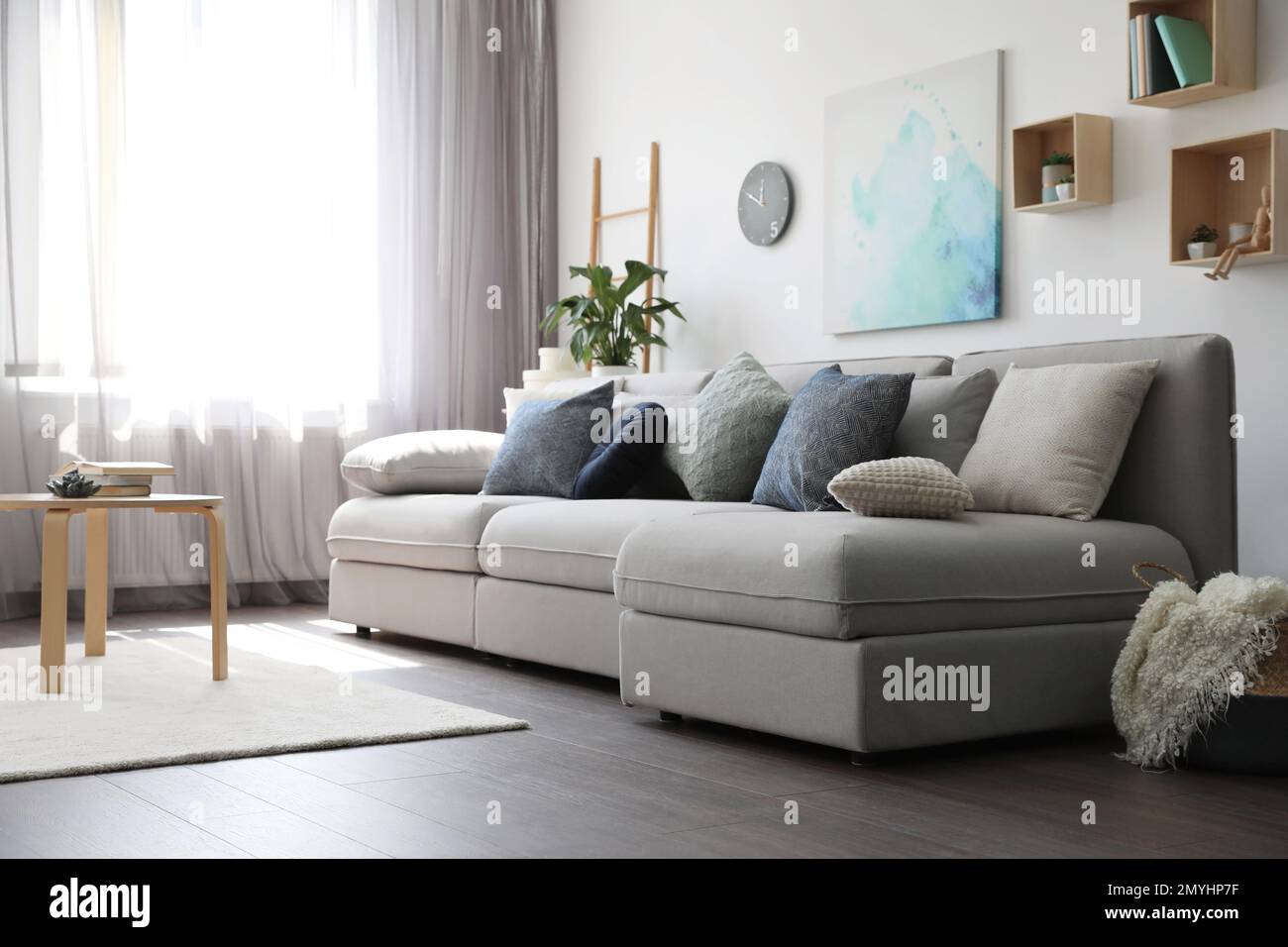 Elegant living room with comfortable sofa near window. Interior design ...