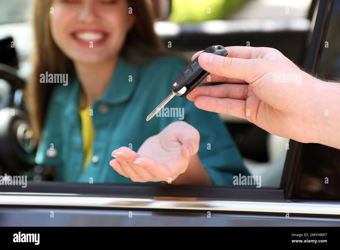 Salesperson giving car key to customer, focus on hands Stock Photo - Alamy