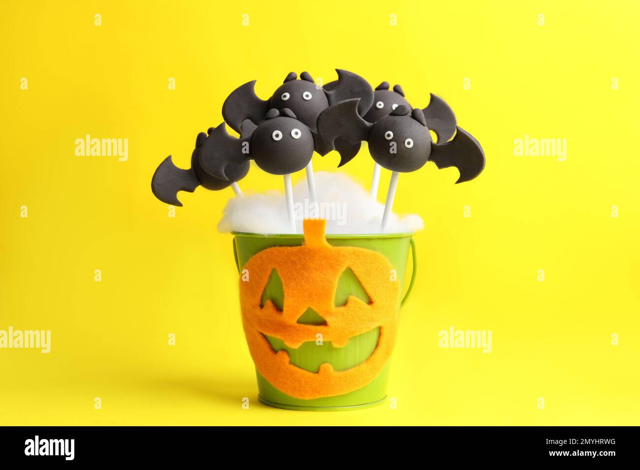 Delicious bat shaped cake pops on yellow background. Halloween treat ...