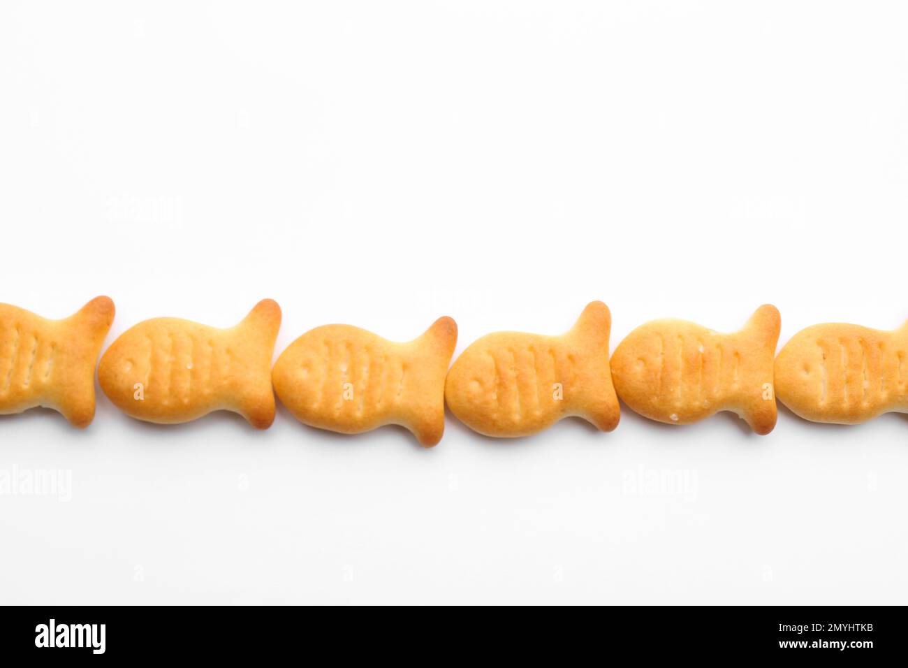 Delicious crispy goldfish crackers on white background, top view Stock ...