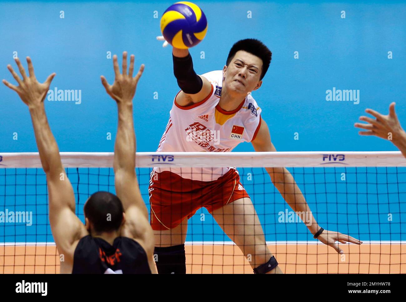 Zhang Chen of China spikes against Justin Duff of Canada during their ...