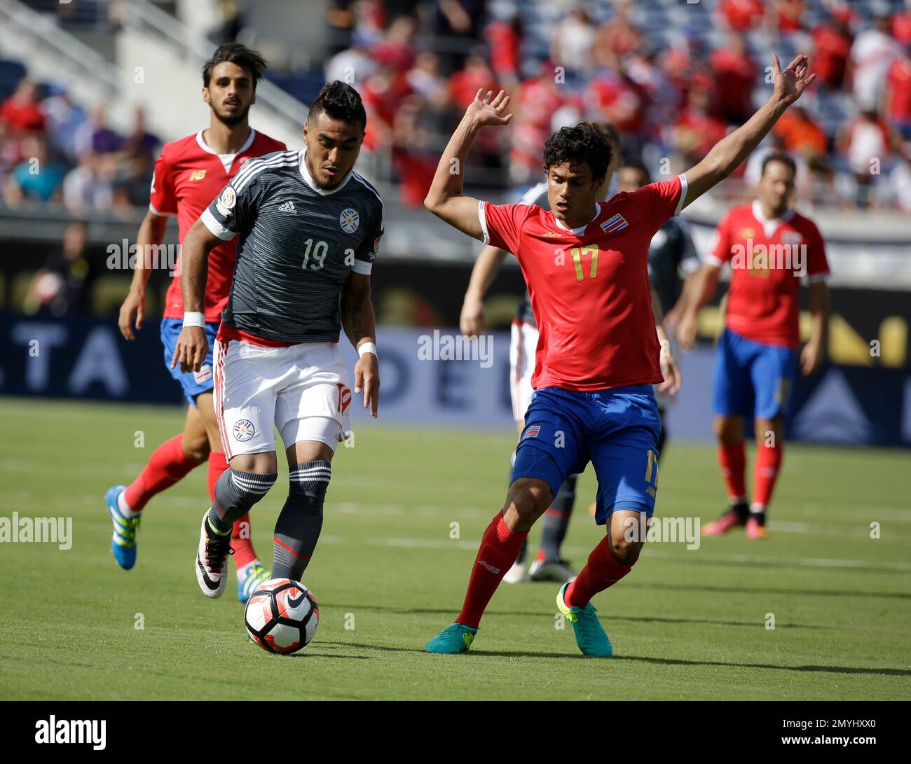 Paraguay's Dario Lezcano (19) moves the ball past Costa Rica's Yeltsin Tejeda (17) during the ...