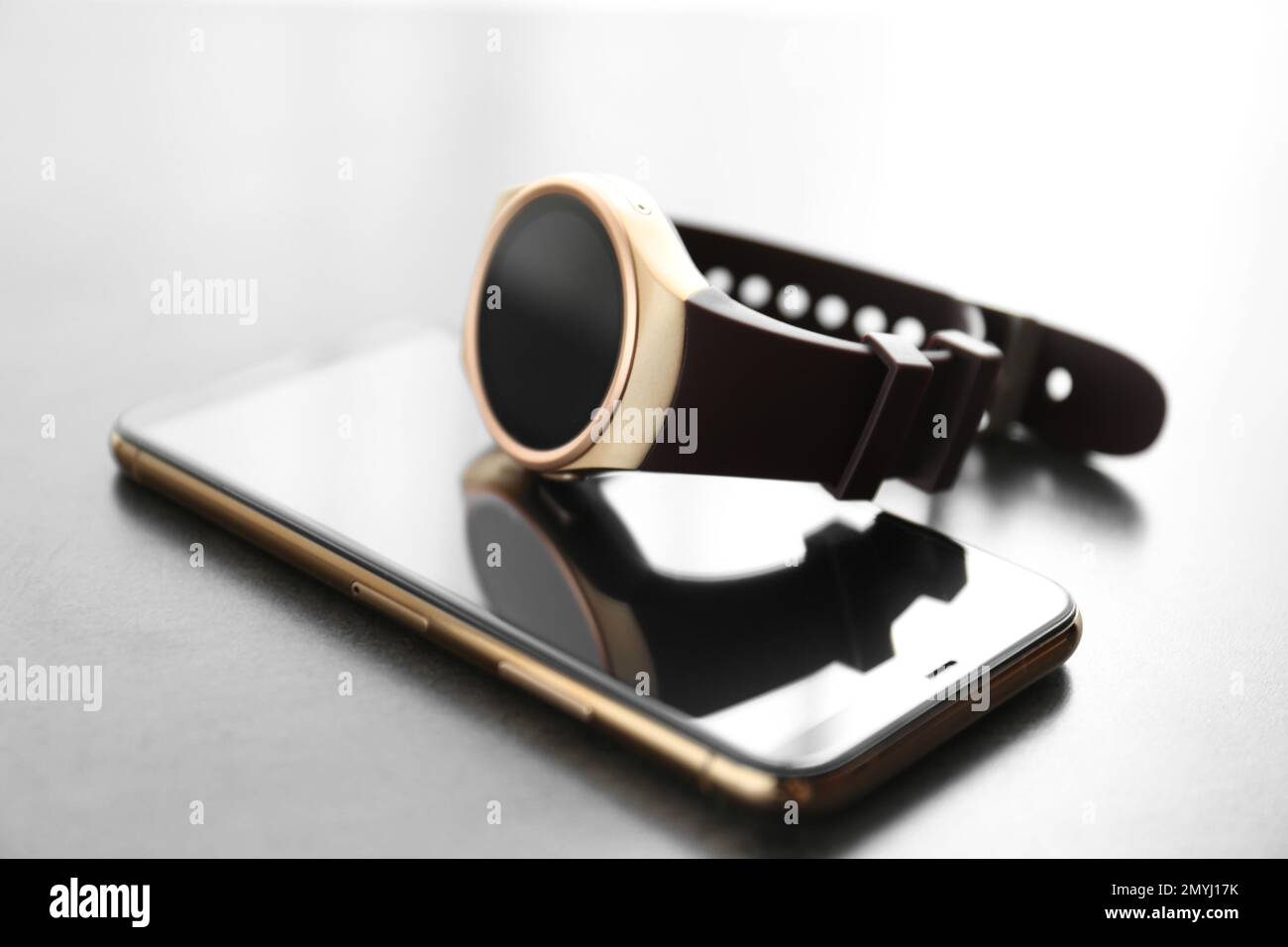 Stylish smart watch and phone on grey table, closeup Stock Photo - Alamy