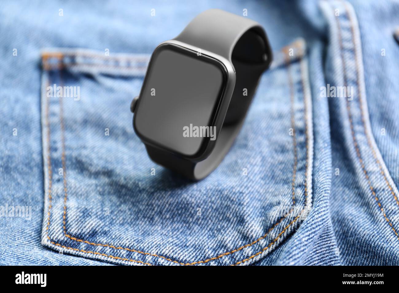 Modern stylish smart watch on jeans, closeup Stock Photo - Alamy