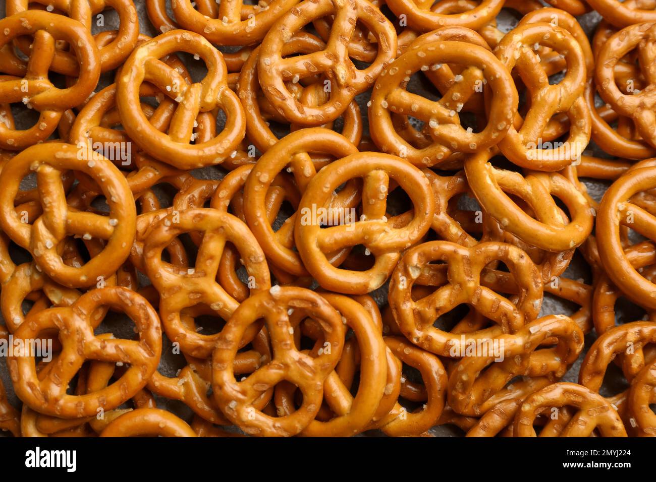Many delicious pretzel crackers as background, top view Stock Photo - Alamy
