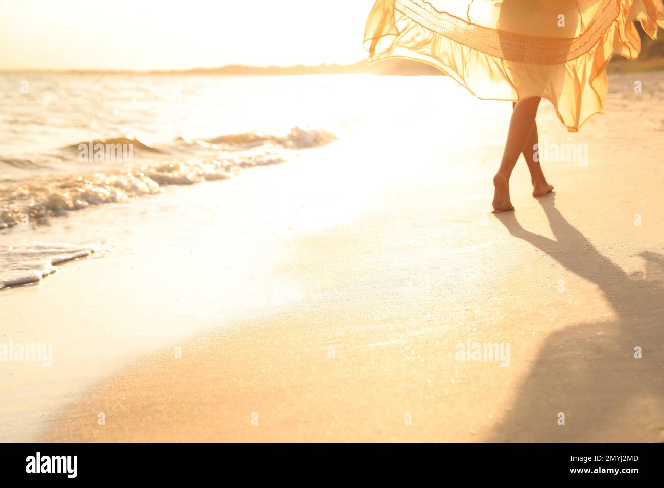 Young woman walking at beach hi-res stock photography and images - Alamy