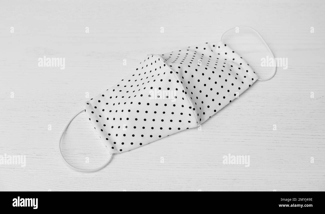 Handmade cloth mask on white wooden background. Personal protective ...