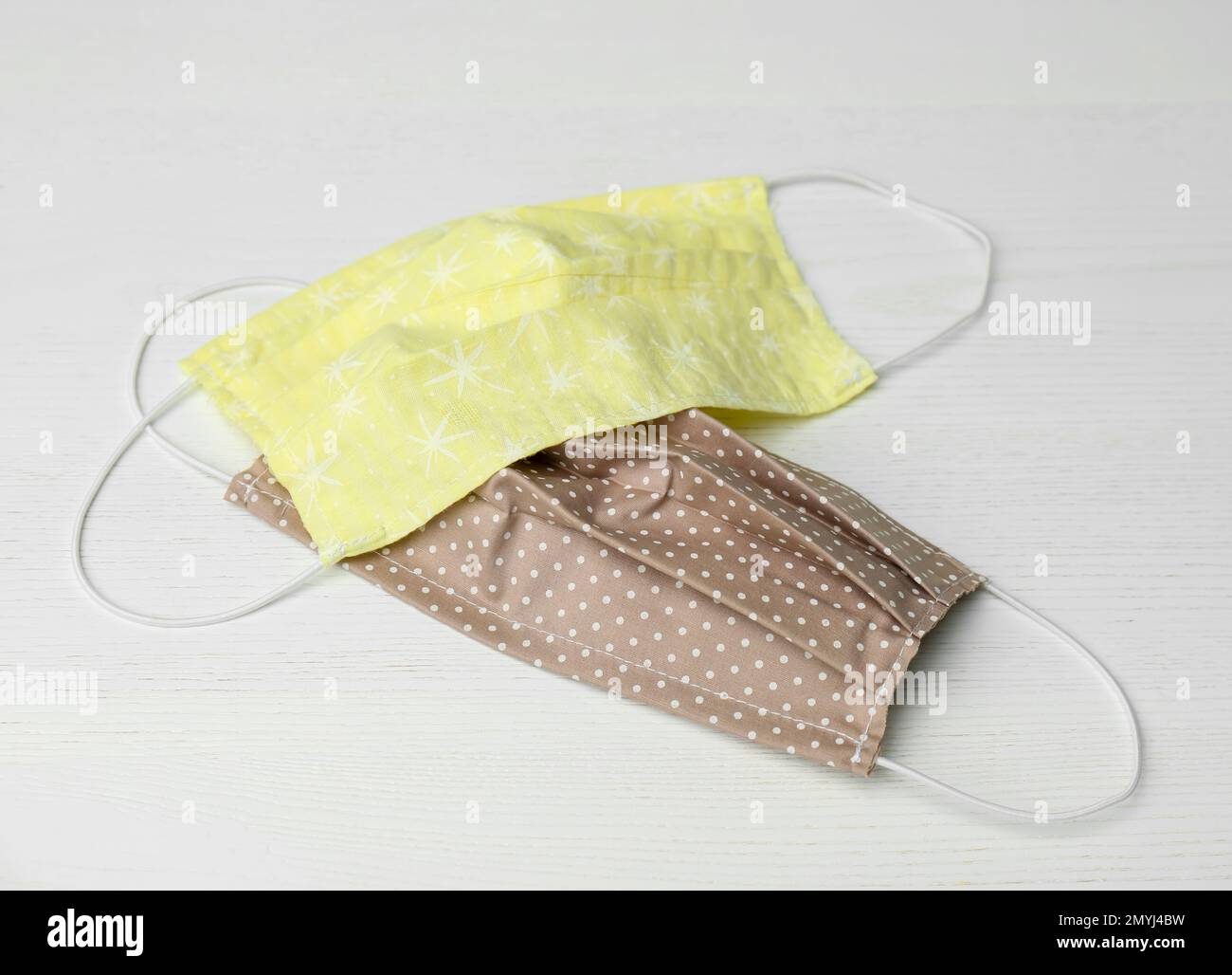 Handmade cloth masks on white wooden background. Personal protective ...