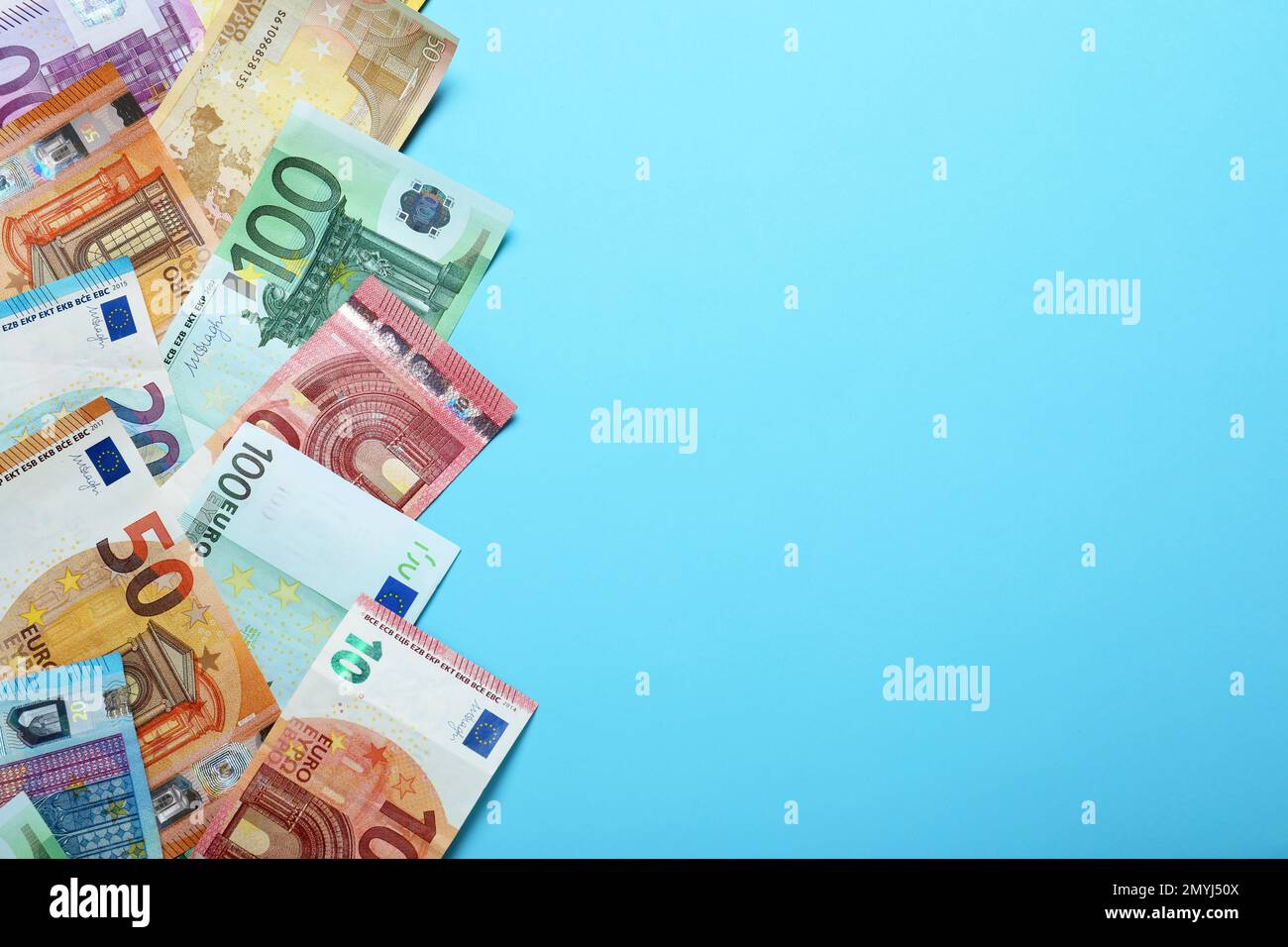 Money on light blue background, flat lay. Space for text Stock Photo ...
