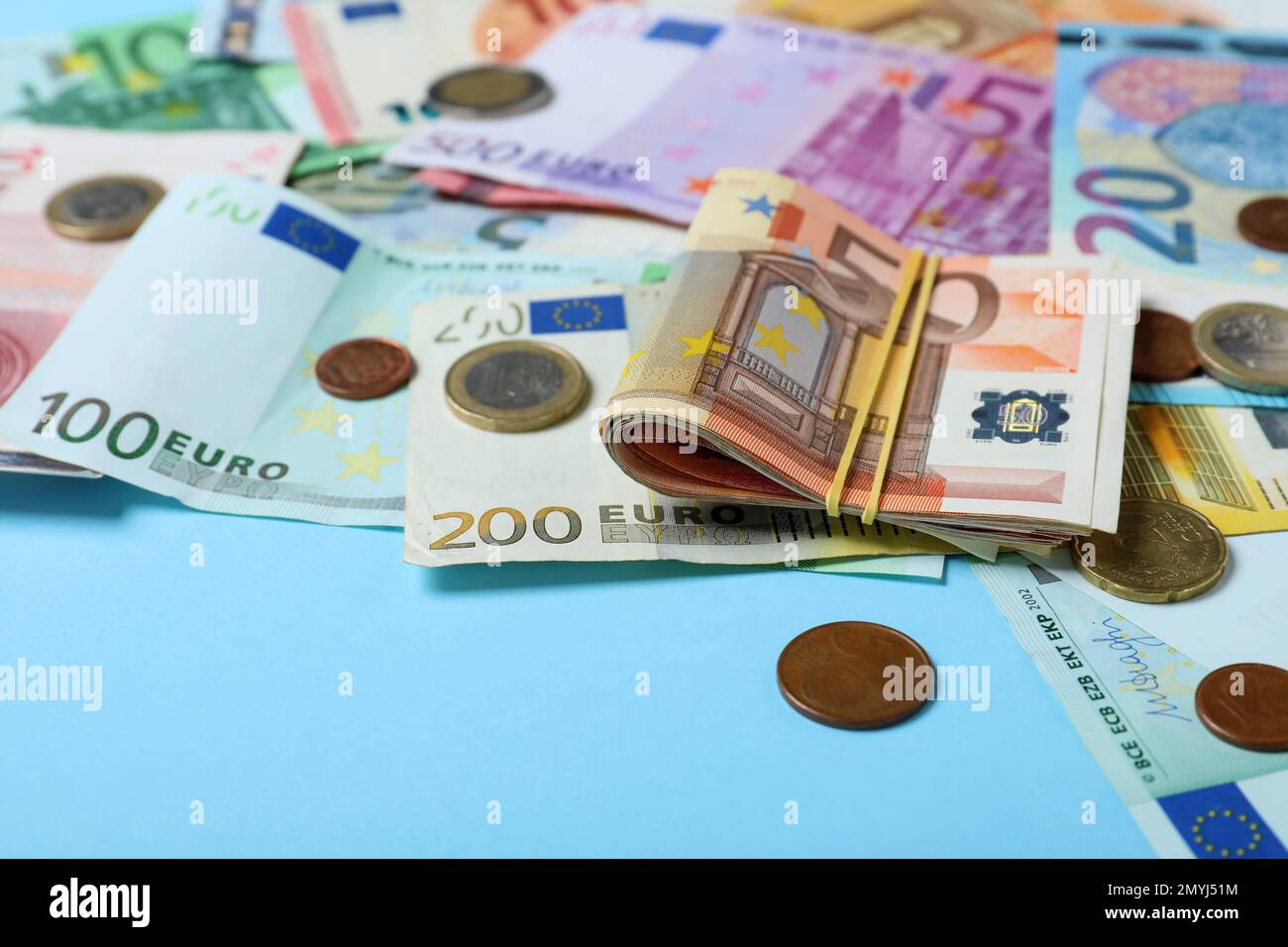 Money on light blue background, closeup. Space for text Stock Photo - Alamy