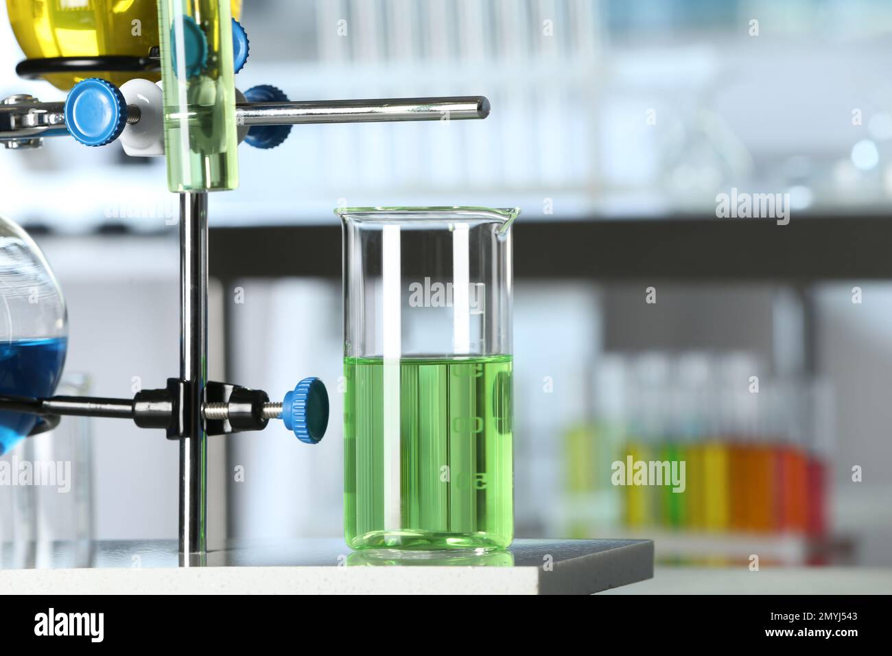 Laboratory glassware with different liquid samples, focus on beaker ...