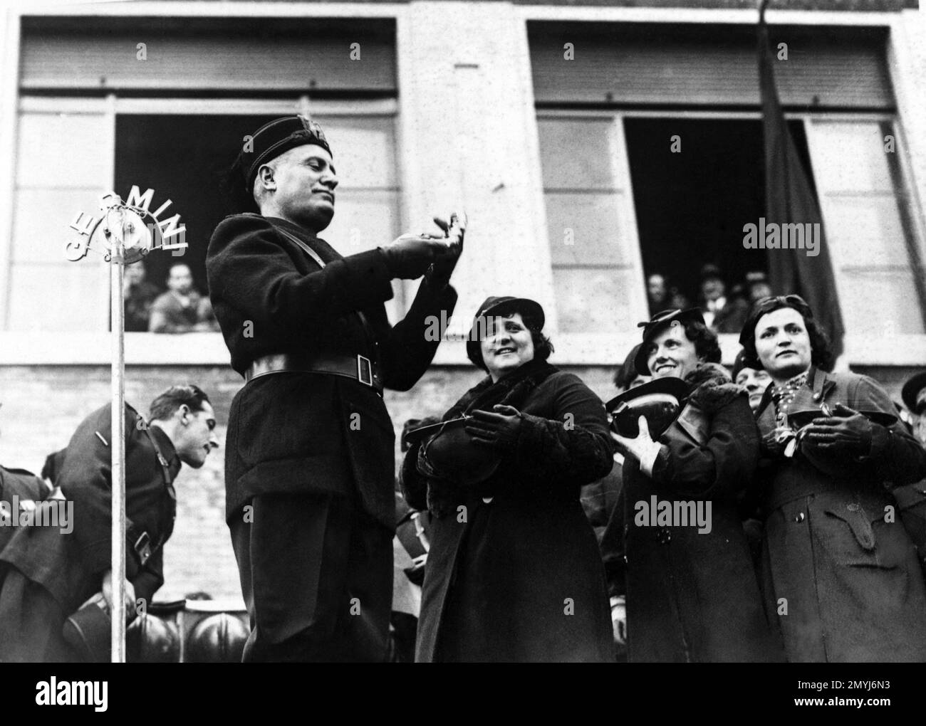 Signor Mussolini receiving offerings from women when he made his speech ...