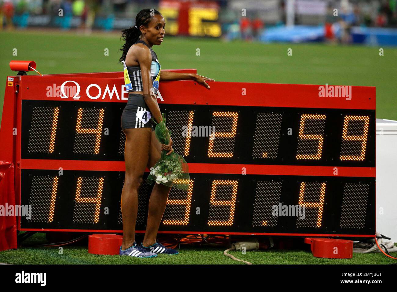 Ethiopia's Almaz Ayana stands near the time board after crossing the ...