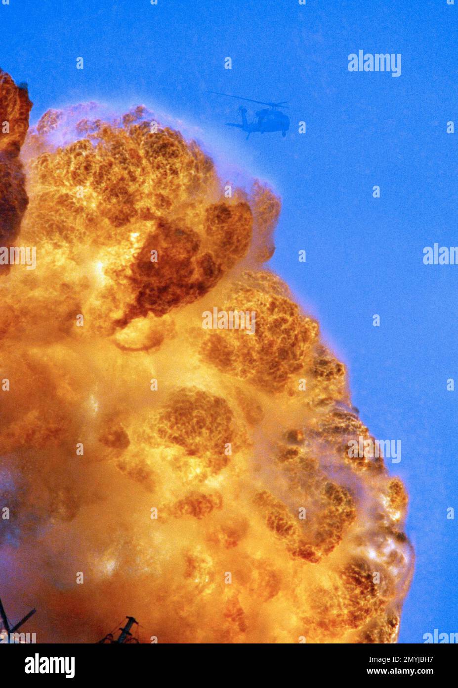 An allied military helicopter is dwarfed by the massive fireball form ...