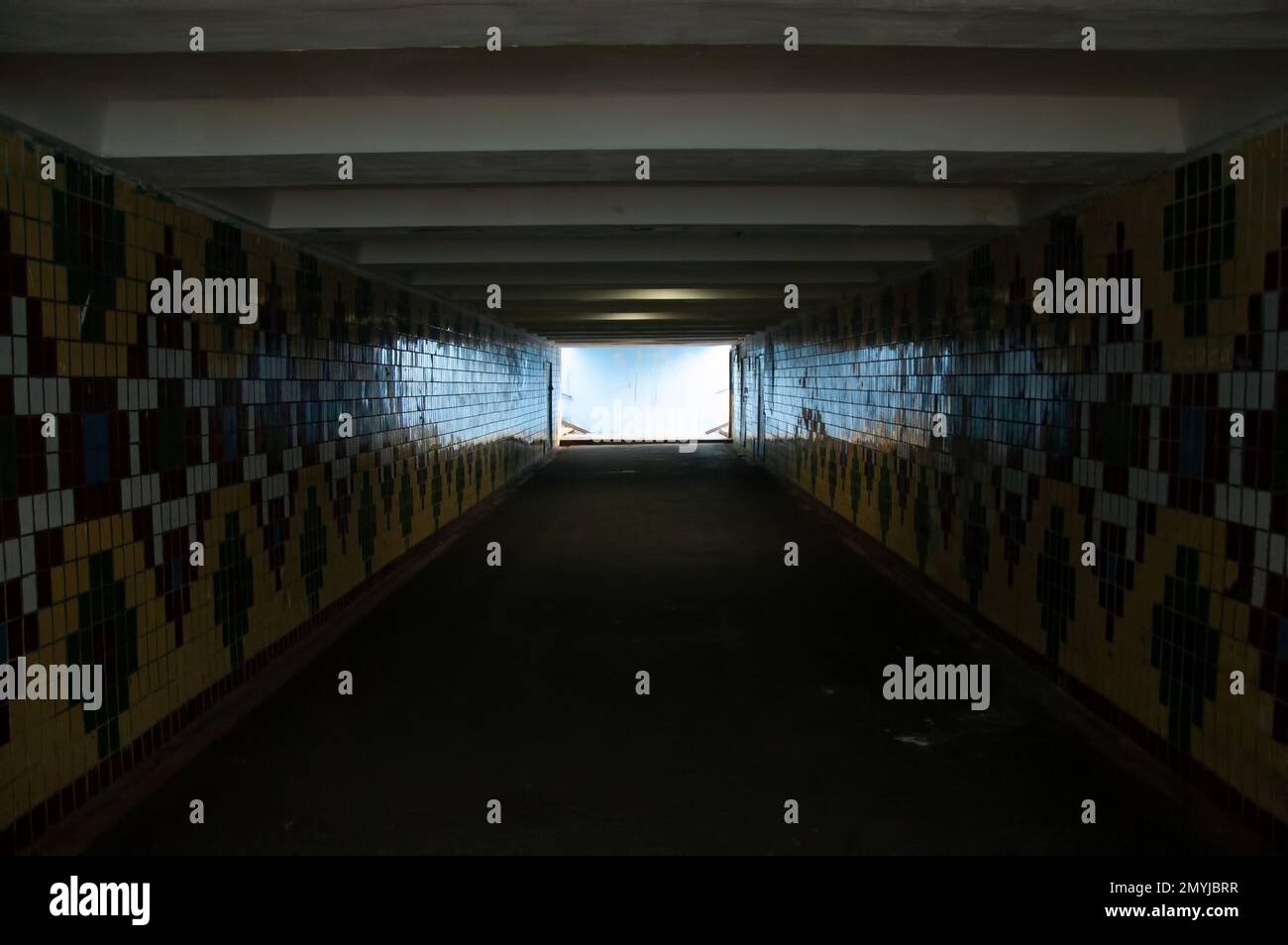 dark underpass, tiled walls, light at the end of the tunnel Stock Photo ...
