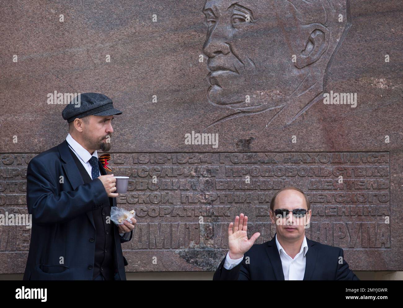 Men resembling Soviet founder Vladimir Lenin, left, and Russian ...
