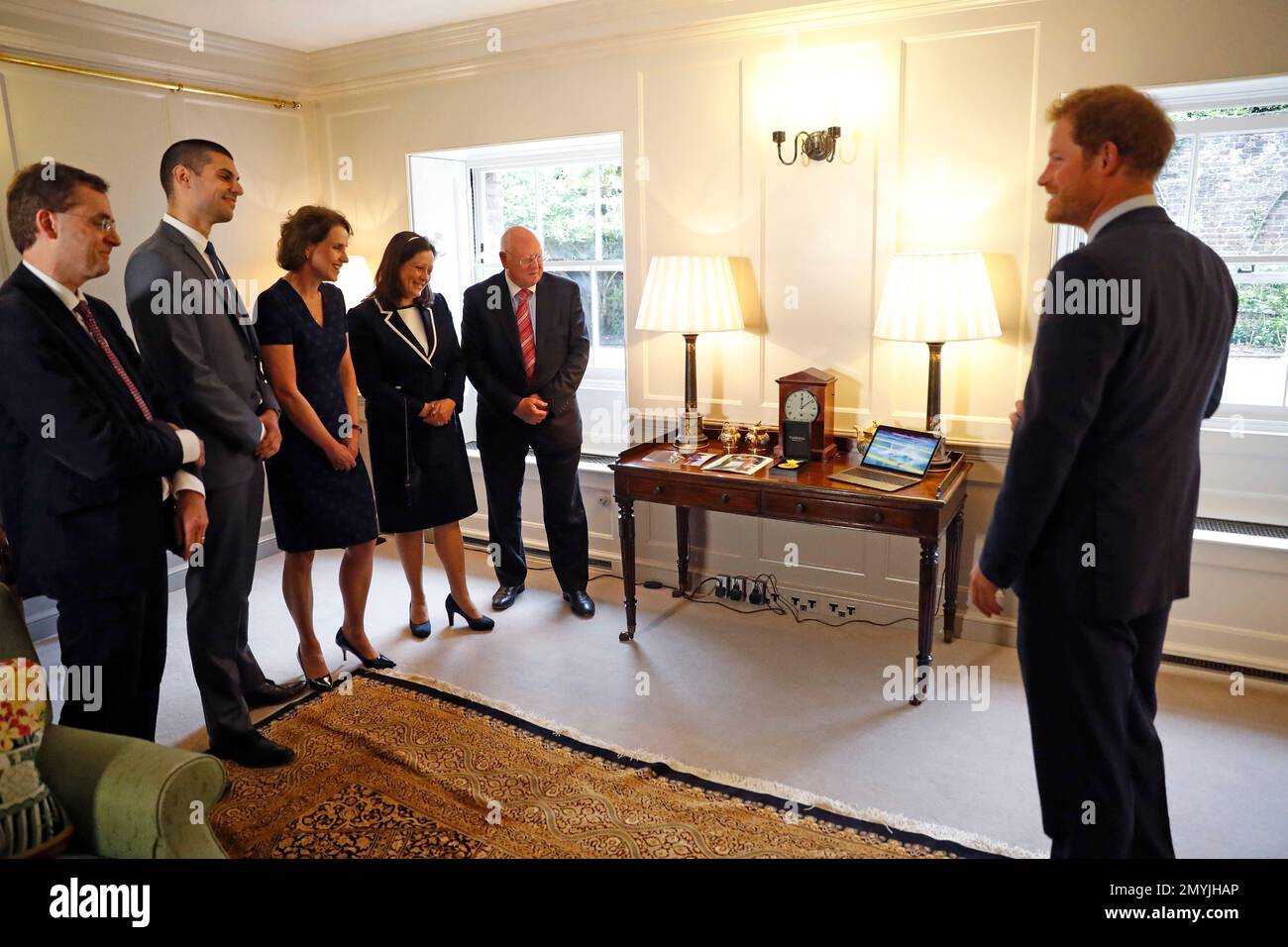 Britain's Prince Harry, right, shows a video of U.S. Staff Sergeant ...