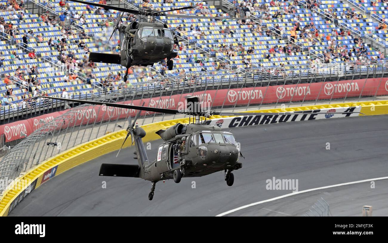 U.S. Army Black Hawk helicopters descend into the Charlotte Motor ...