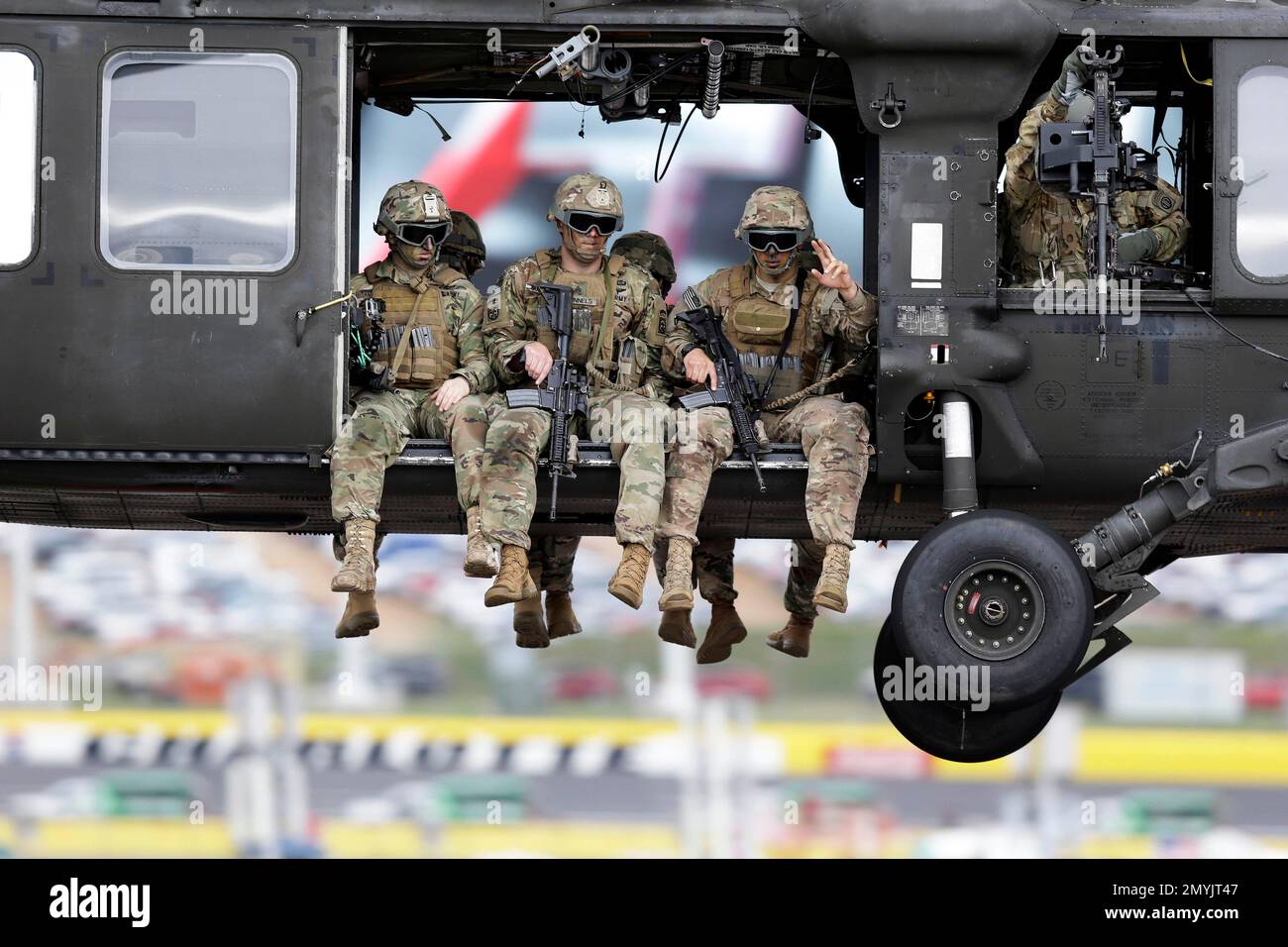 A U.S. Army repel team with the 82nd Airborne Division rides in a Black ...
