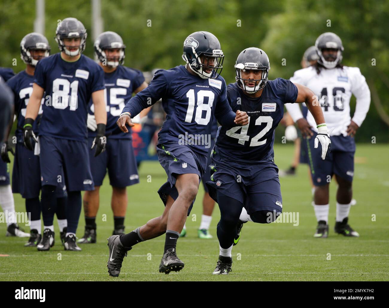 Seattle Seahawks' Kasen Williams (18) and Brandon Cottom run through a ...